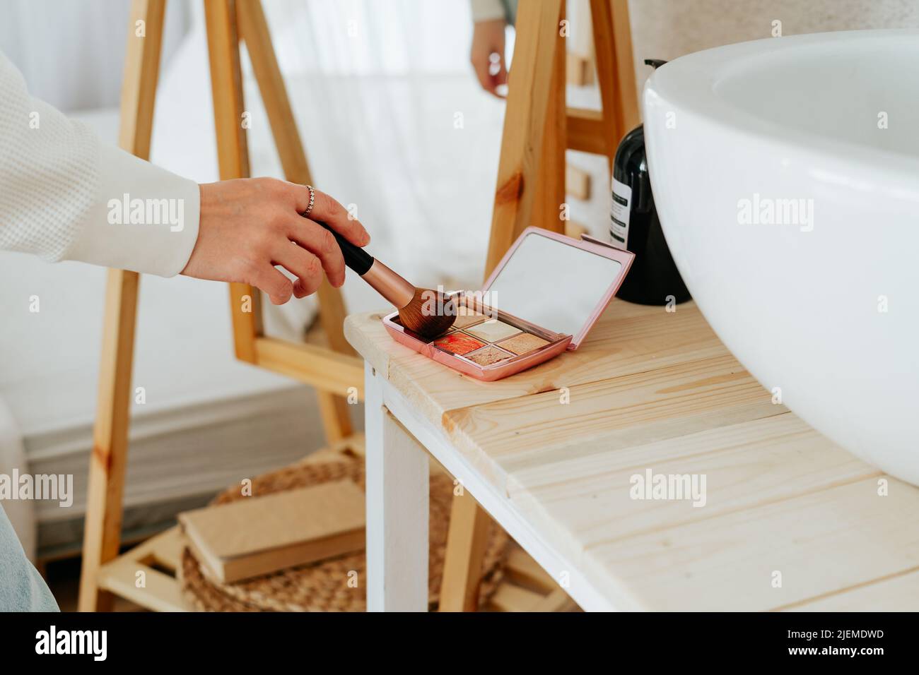 Close up of cropped caucasian woman with long hair holding powder ...