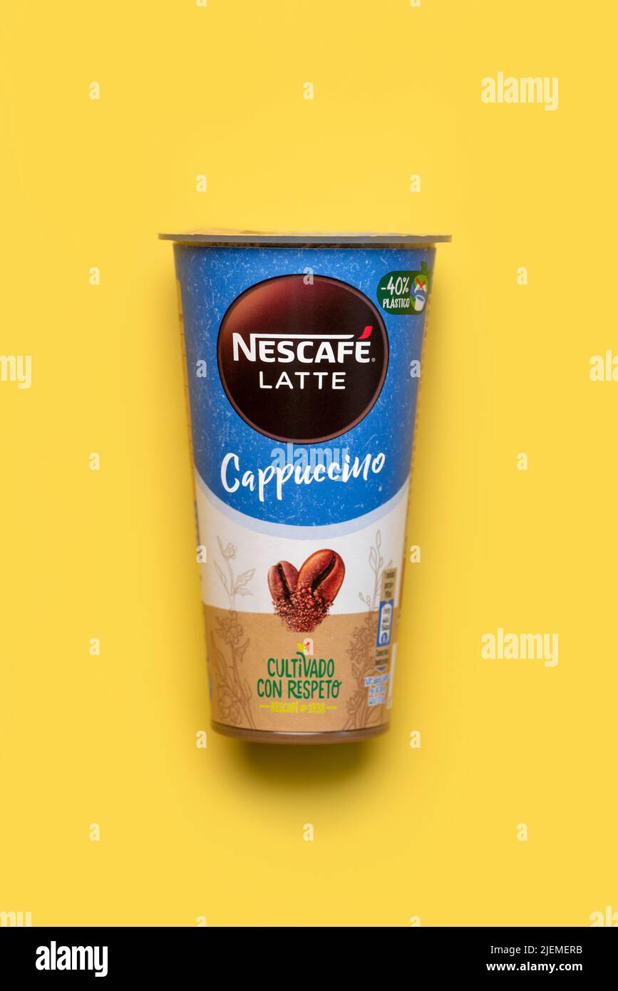Closeup of take away cup of Nescafe cappuccino latte coffee on yellow ...