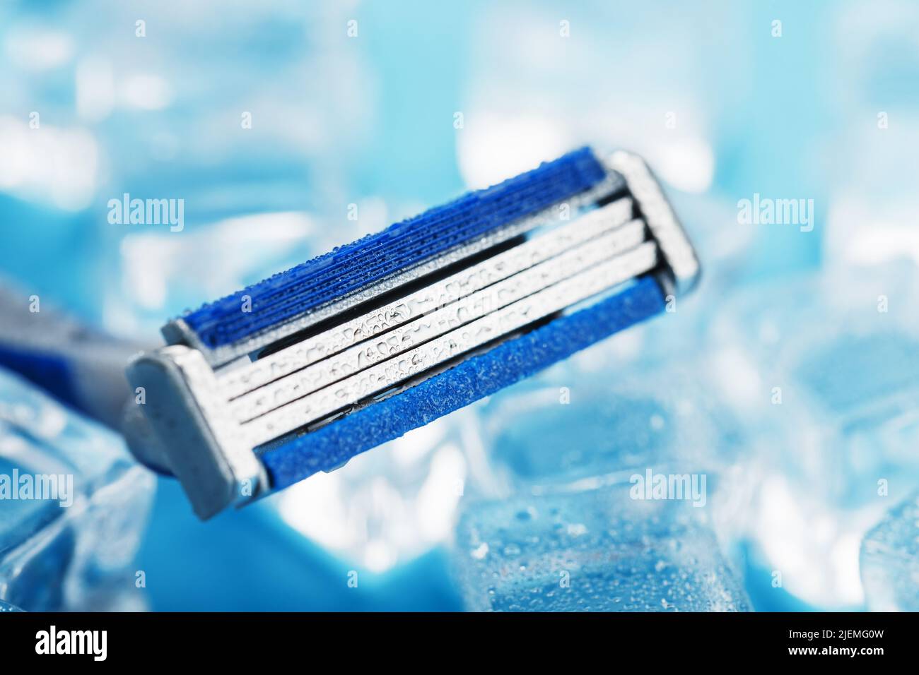 Shaving machine on a blue background with ice cubes. The concept of ...