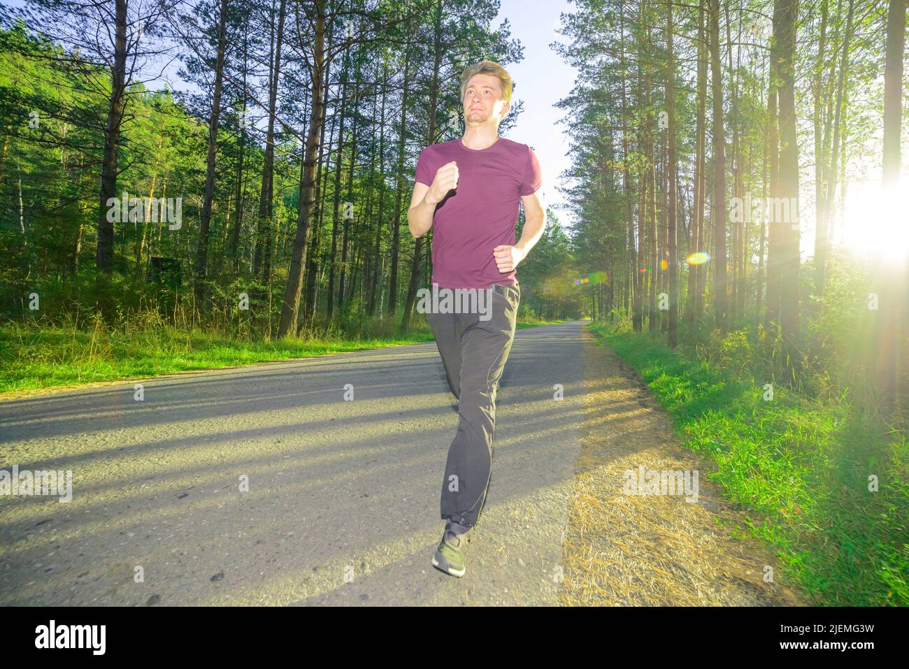 Running man jogging in city park at beautiful summer day. Sport fitness ...