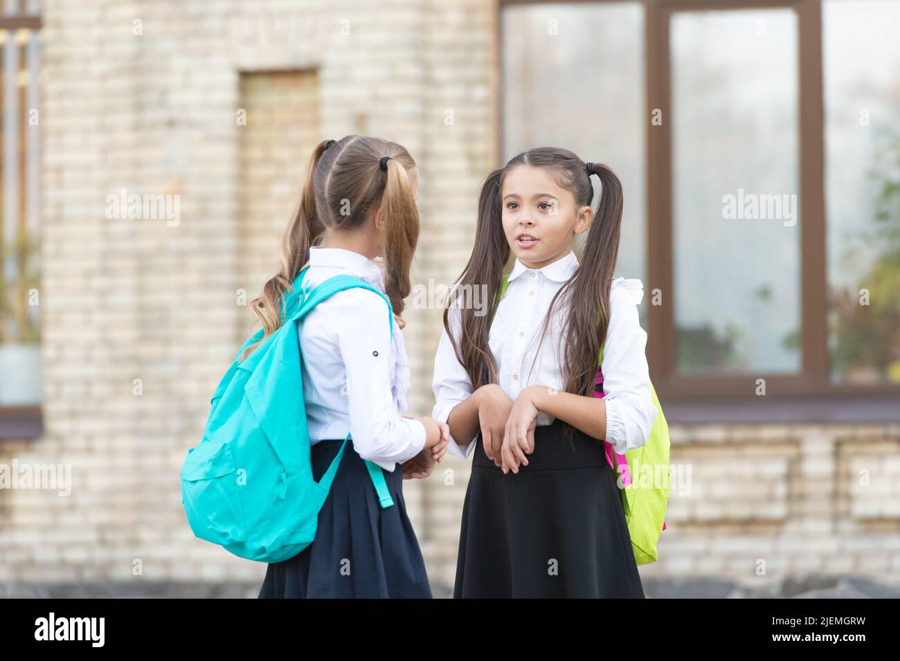 two school girls friends talk together outdoor Stock Photo - Alamy