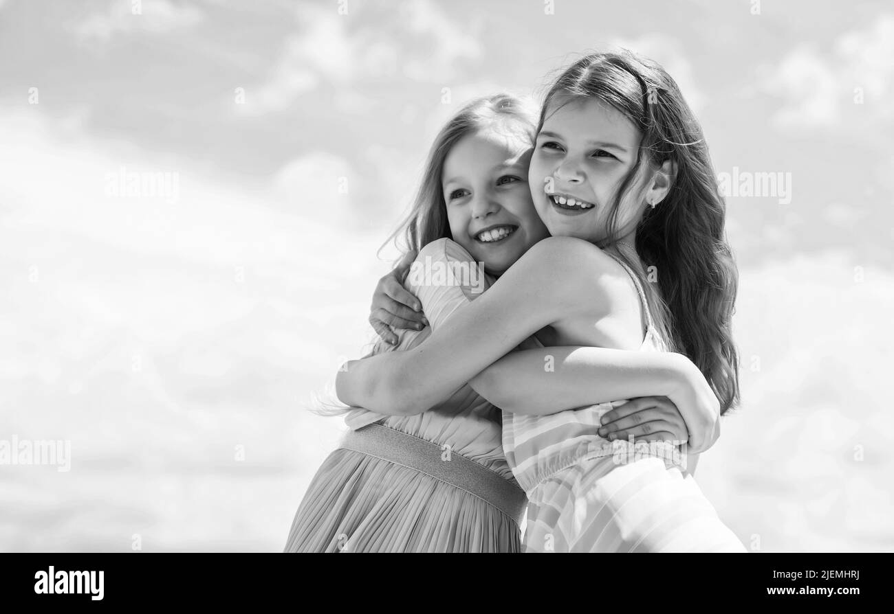 happy children embrace on sky background, family love Stock Photo - Alamy
