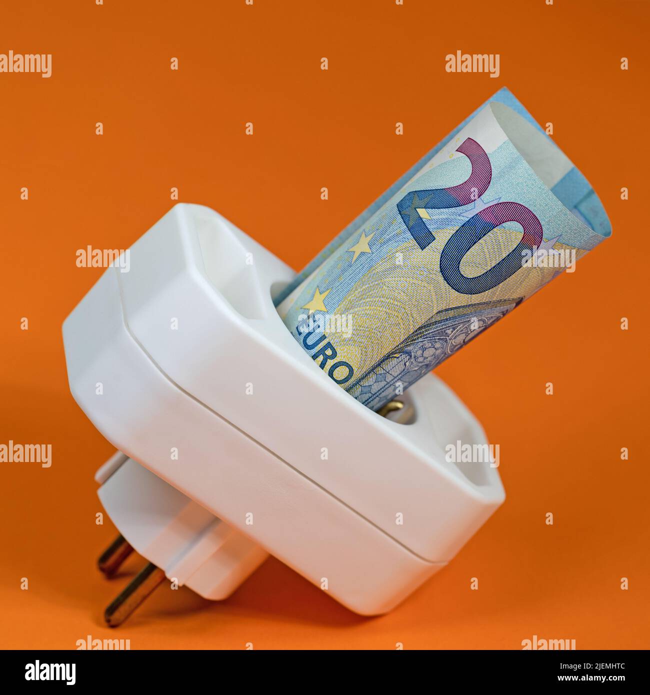 Socket and power plug with money bill Stock Photo - Alamy