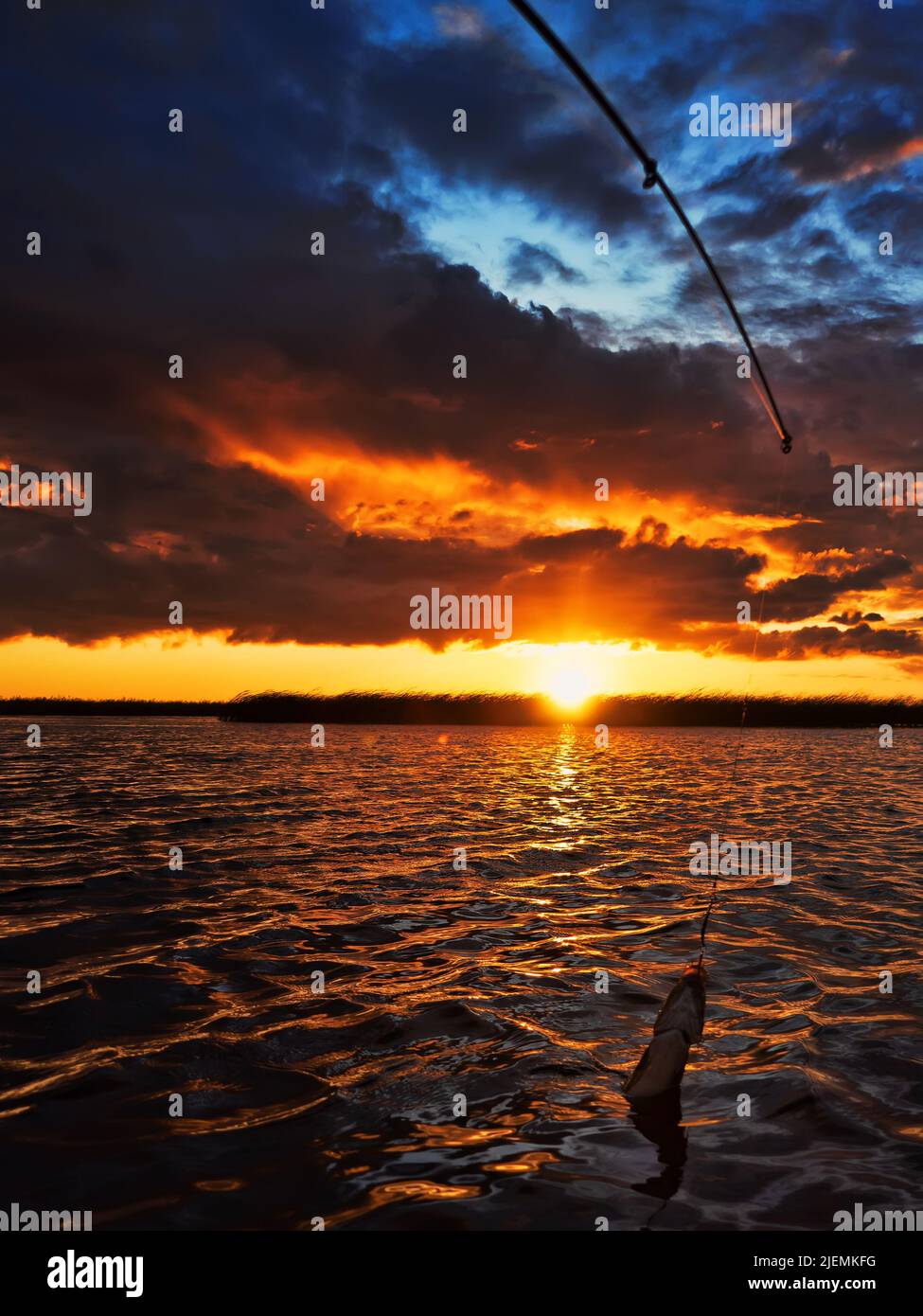 Fishing at sunset. Catching predatory fish on spinning. Sunset colors ...