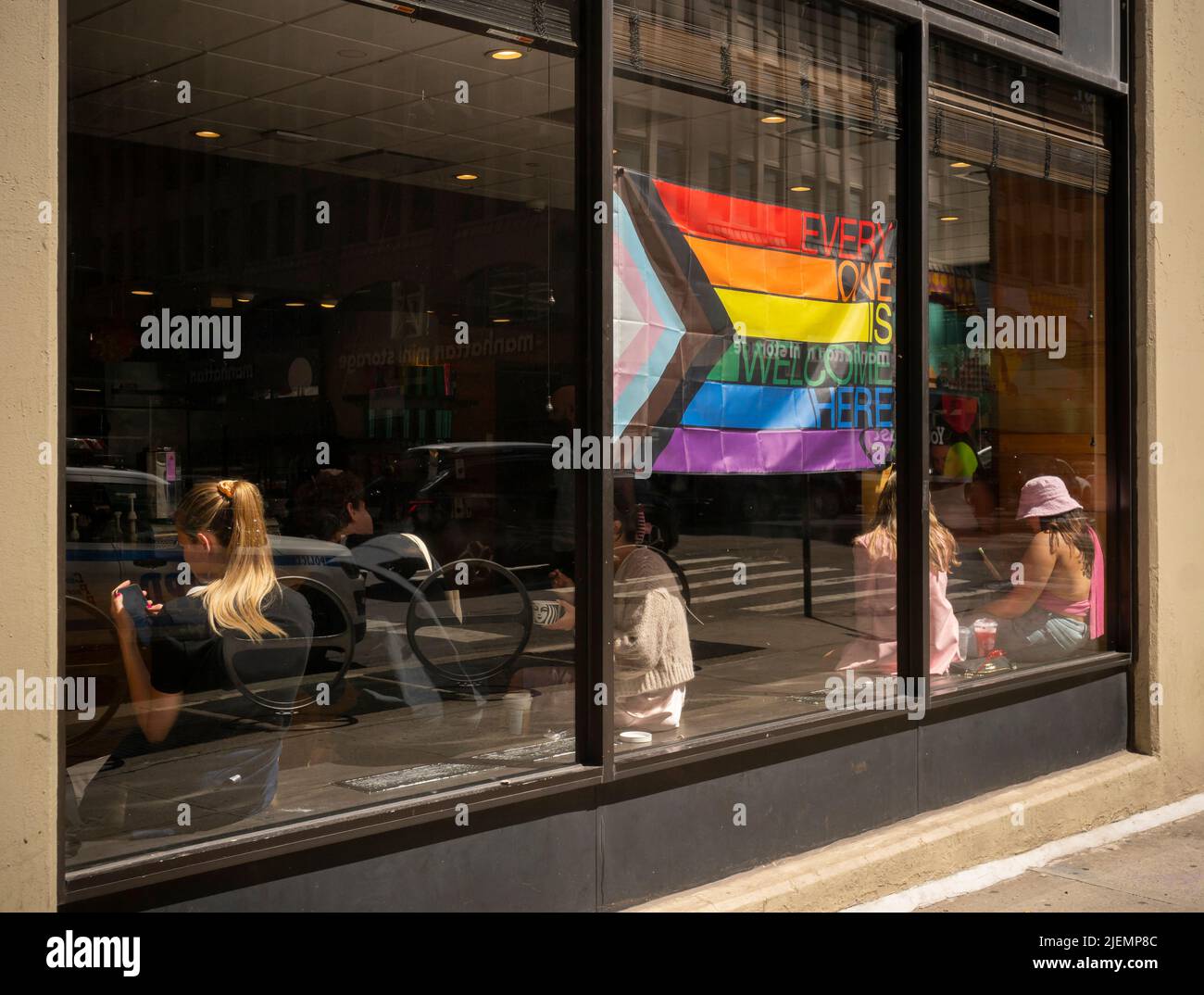 A Starbucks in New York displays the Progress Pride Pride flag on ...