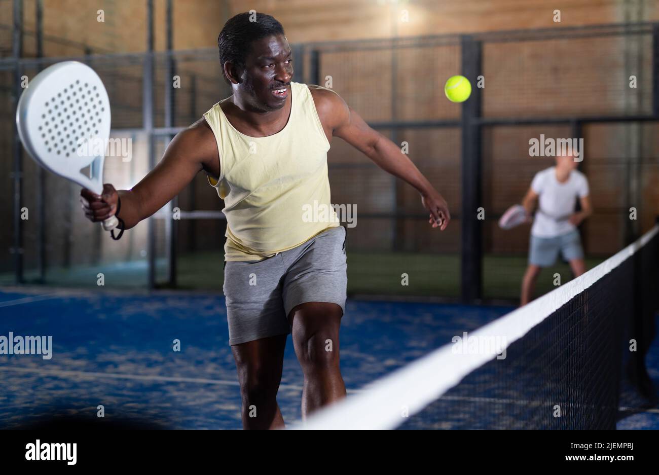 Sporty afro american man playing padel tennis indoor Stock Photo - Alamy