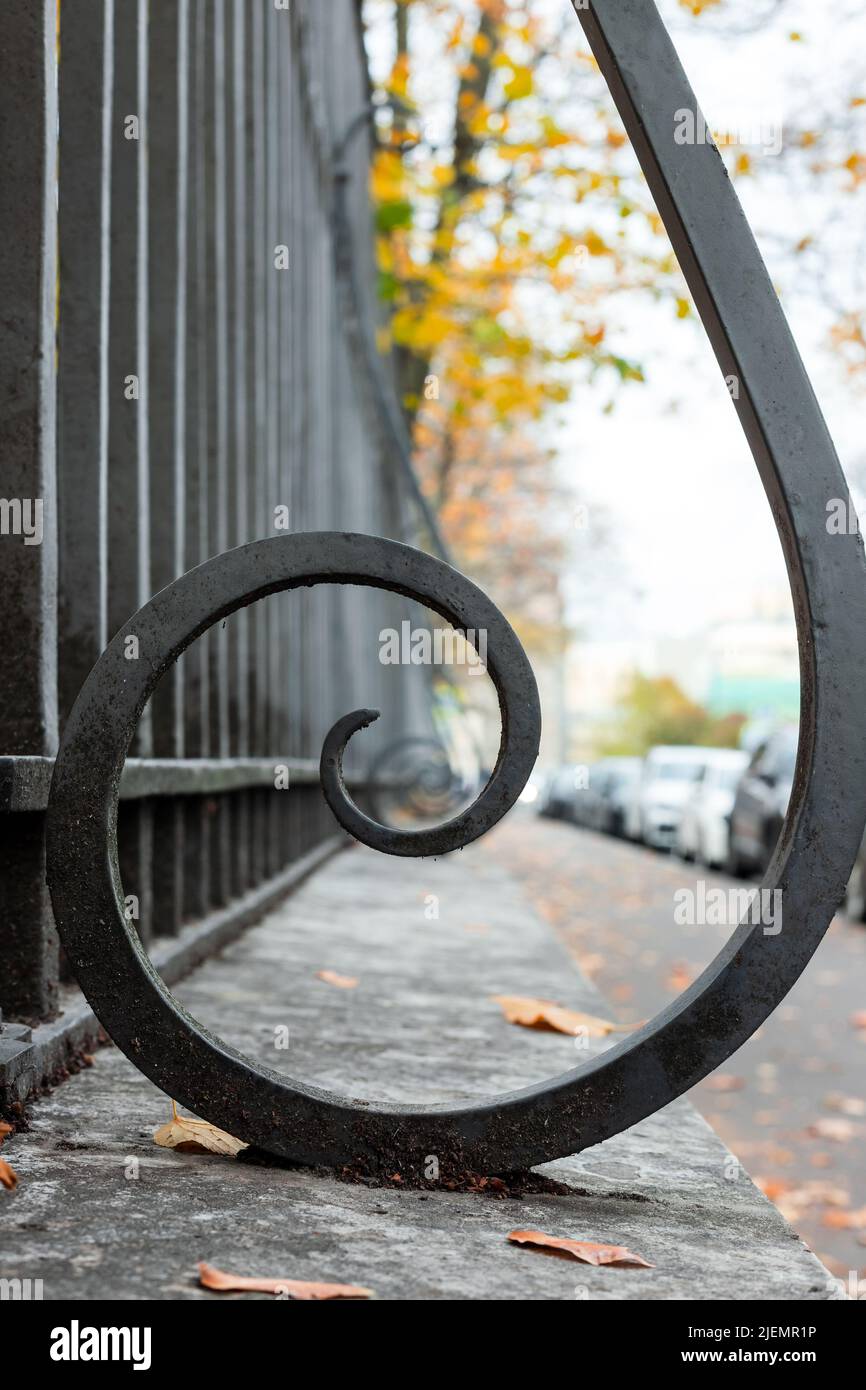 Black forged spiral, metal fence details, close up photo with selective ...