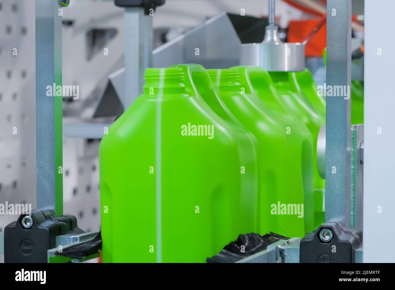 Empty green plastic jerry cans falling from conveyor belt: close up ...