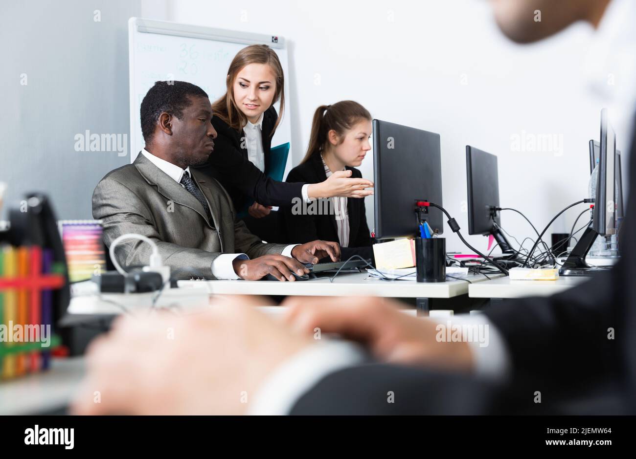 Successful coworkers engaged in business activities in busy open plan ...