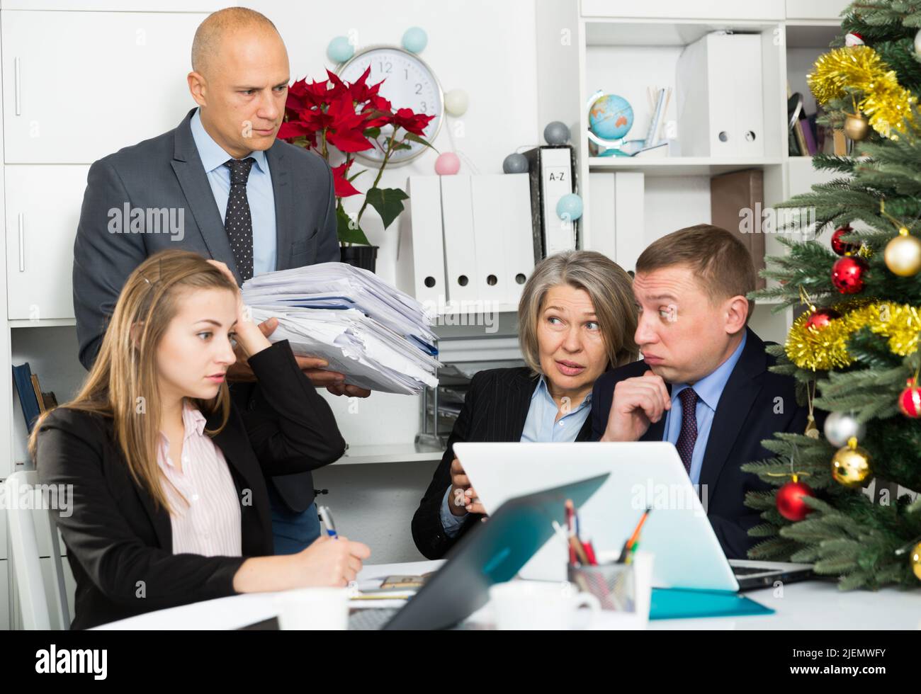 Coworkers unhappy with extra work before Christmas Stock Photo - Alamy