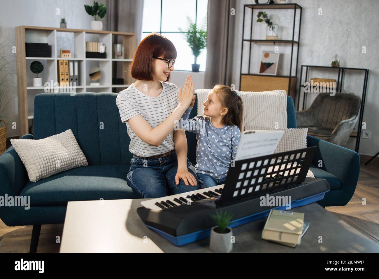 I am the winner. Mother and her agreeable elated pretty little girl ...