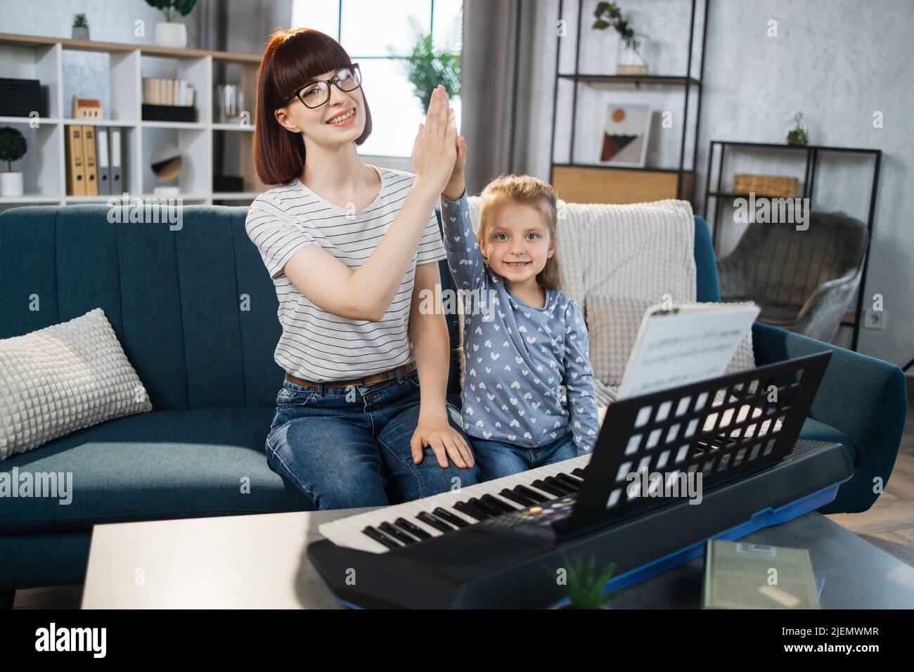 I am the winner. Mother and her agreeable elated pretty little girl ...