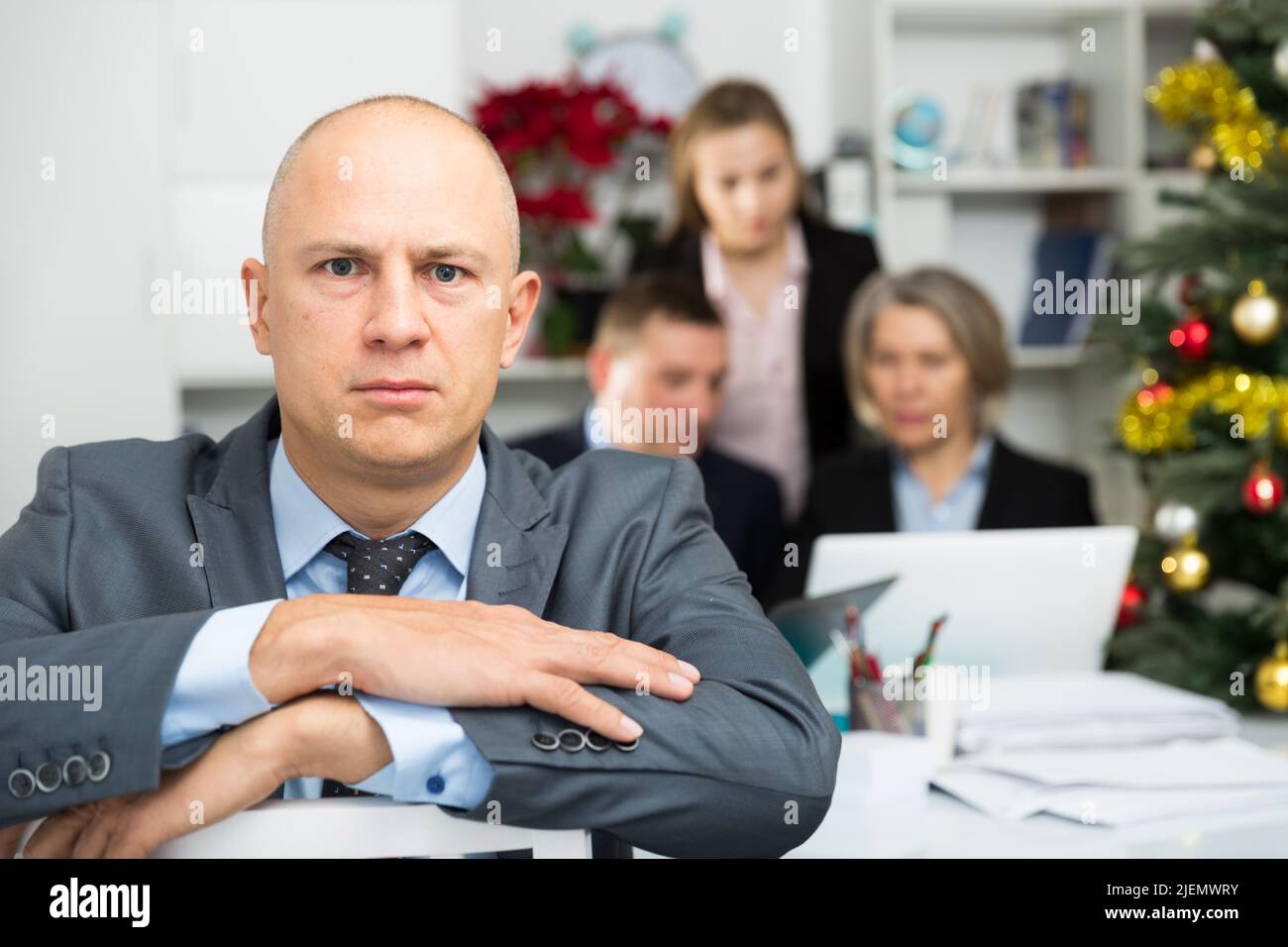 Business team tensely solving problems in office with offended man ...