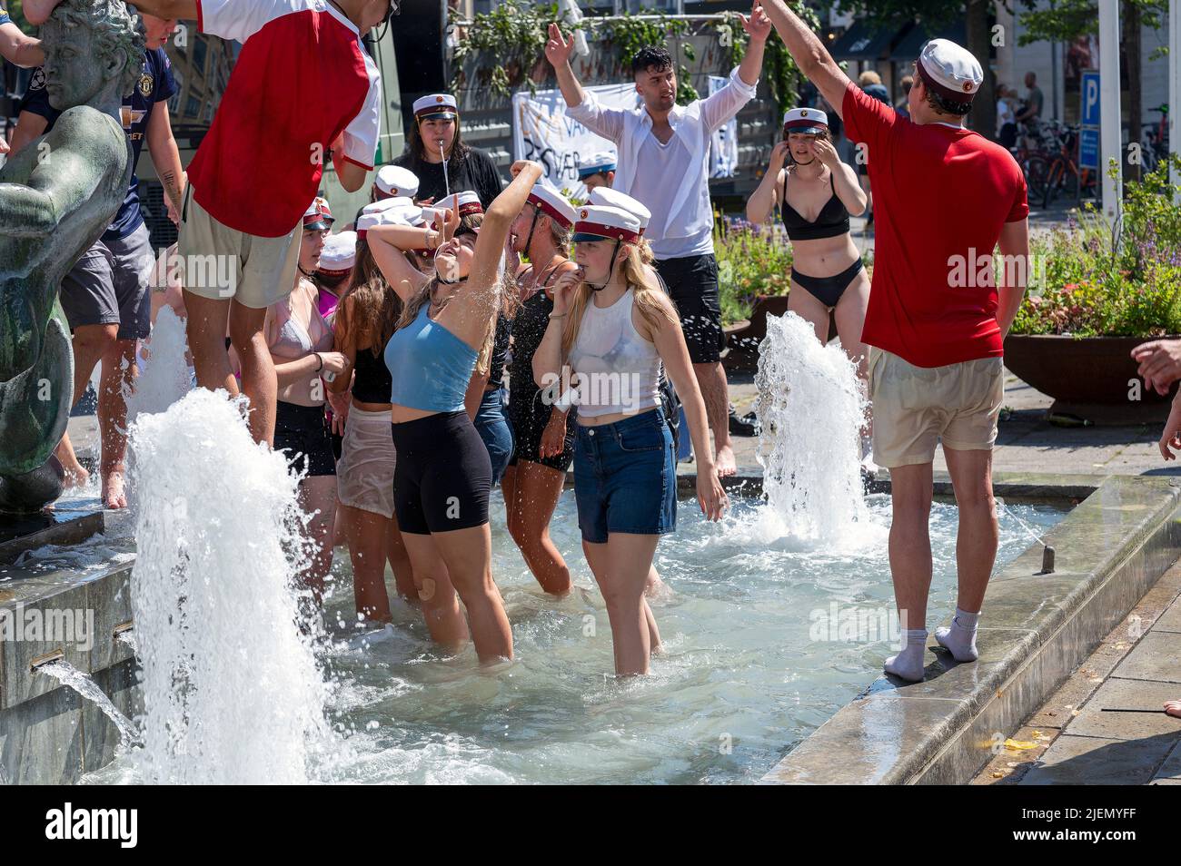 Students in a fountain celebrating graduating from high school in ...