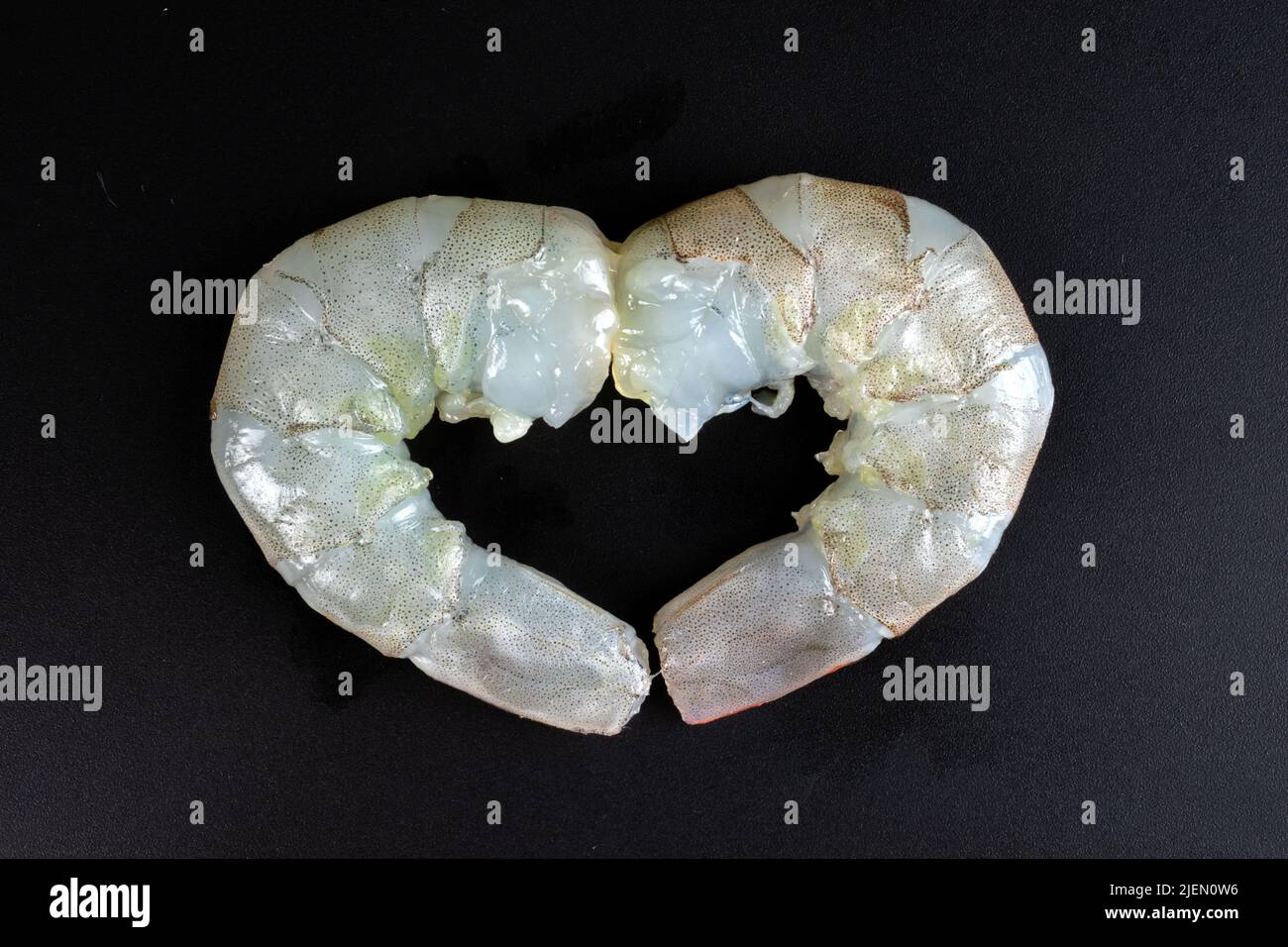 Two raw grey shrimps prawns in shape of heart. Love to seafood concept ...