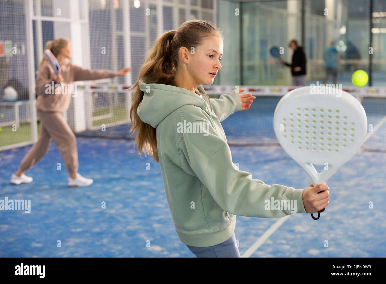 Young girl with racquet playing padel Stock Photo - Alamy