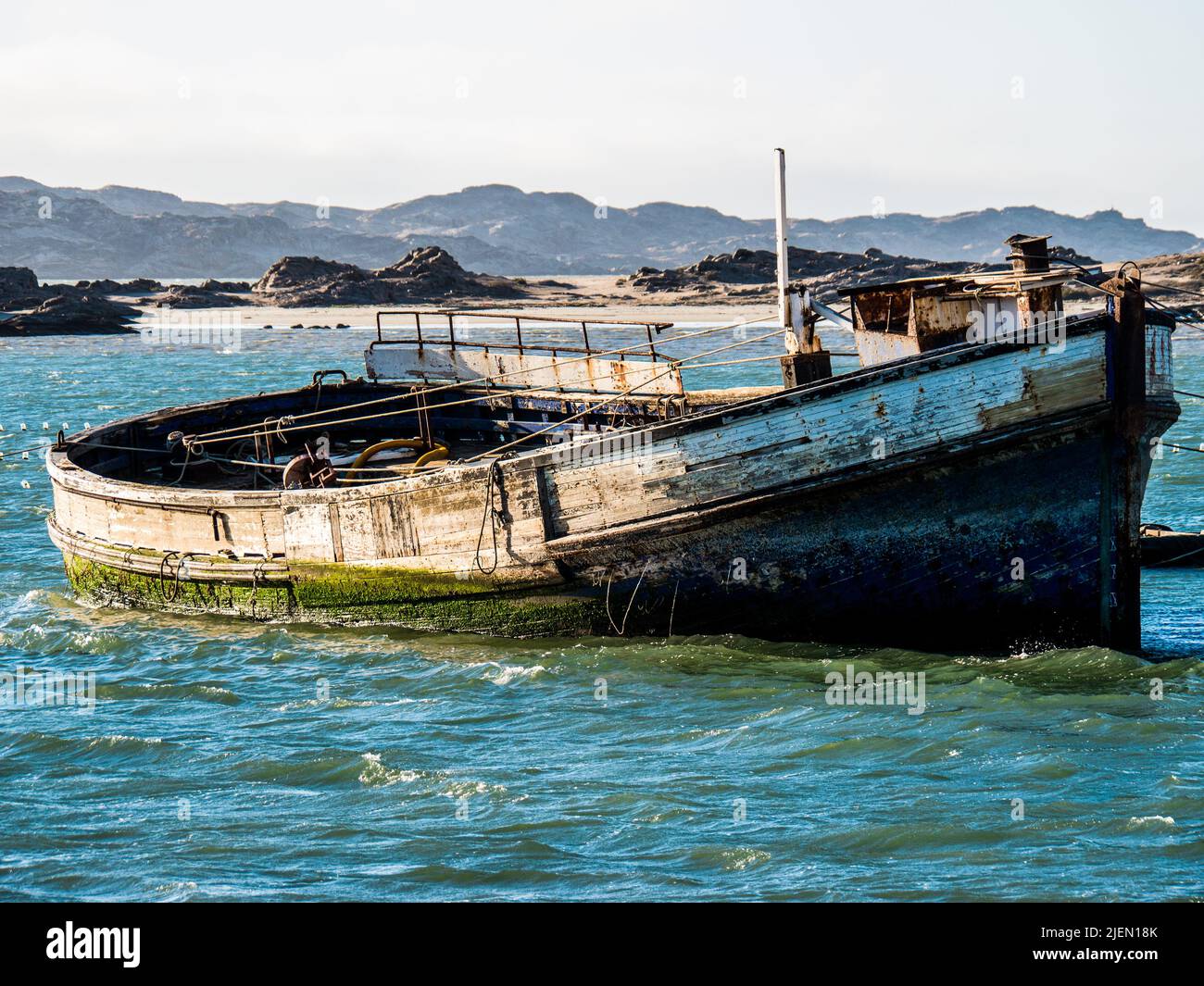 An old deserted boat in the sea Stock Photo - Alamy
