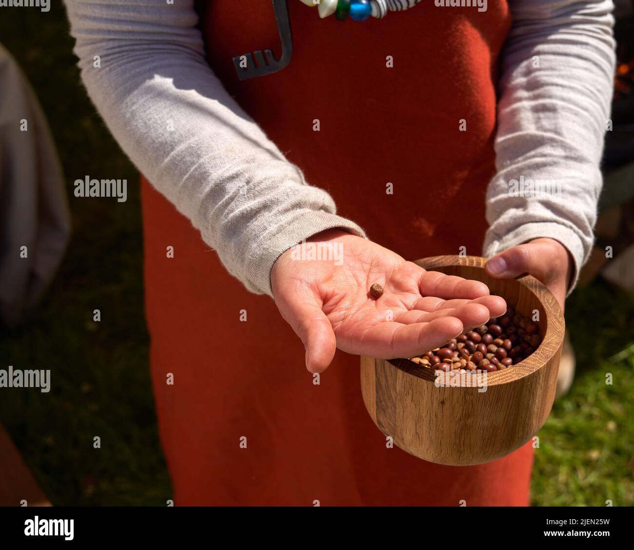 Woman holding a dry pea in the palm of her hand Stock Photo - Alamy