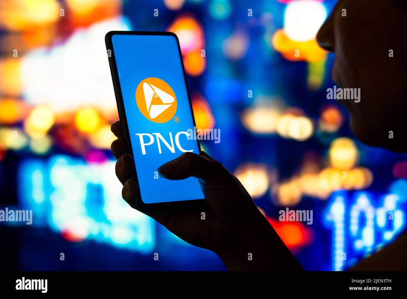 In this photo illustration, a silhouetted woman holds a smartphone with ...