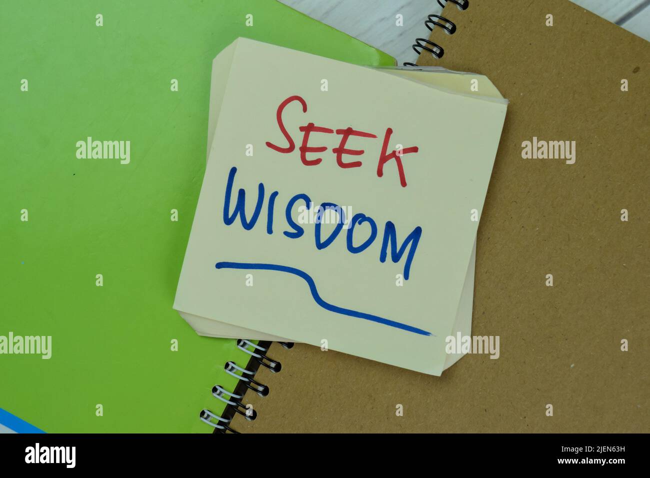 Concept of Seek Wisdom write on sticky notes isolated on Wooden Table ...