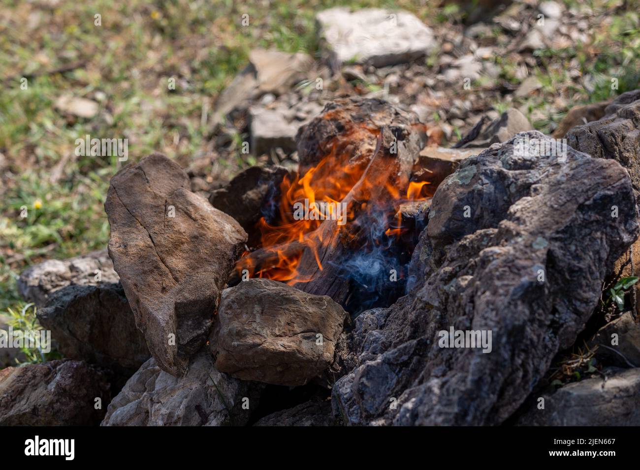 Campfire between stone. Making a fire in nature Stock Photo - Alamy