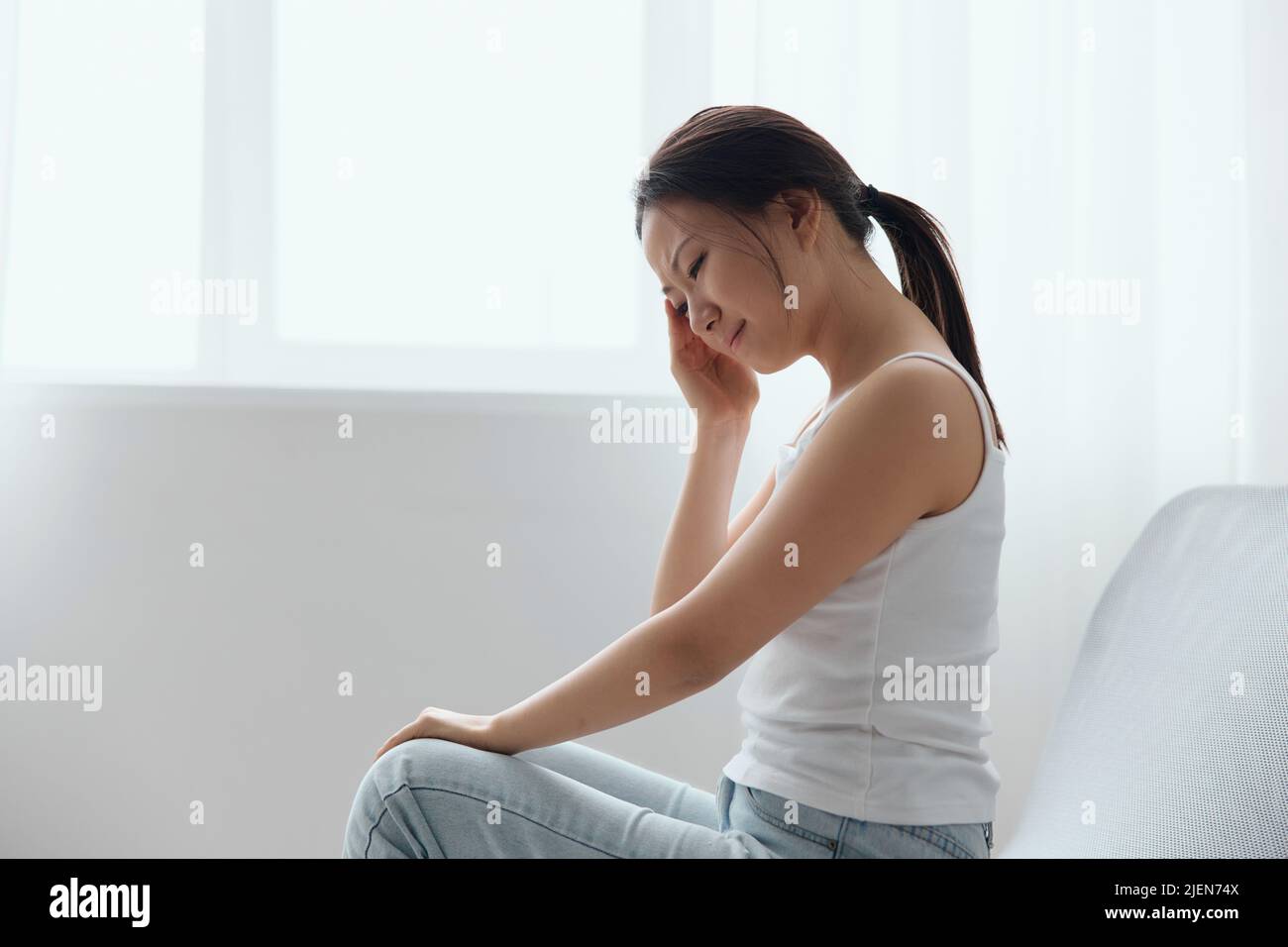 Migraine. Side view of unhappy suffering from headache tanned beautiful ...