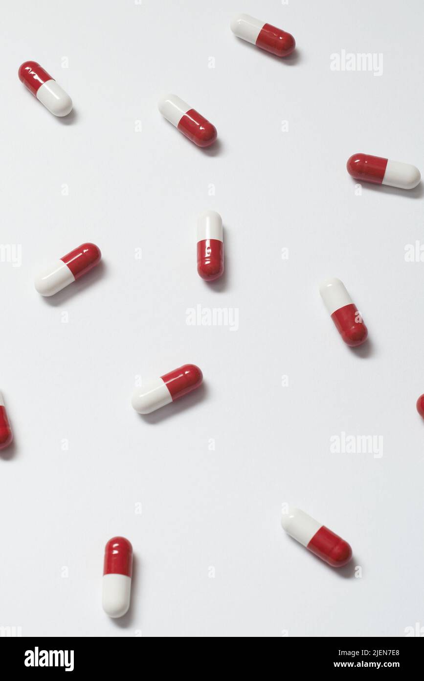 Pharmaceutical capsules over white backdrop Stock Photo - Alamy