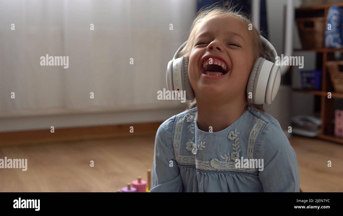 Child Listening Music In Big White Headphones. Happy Little Preschool ...