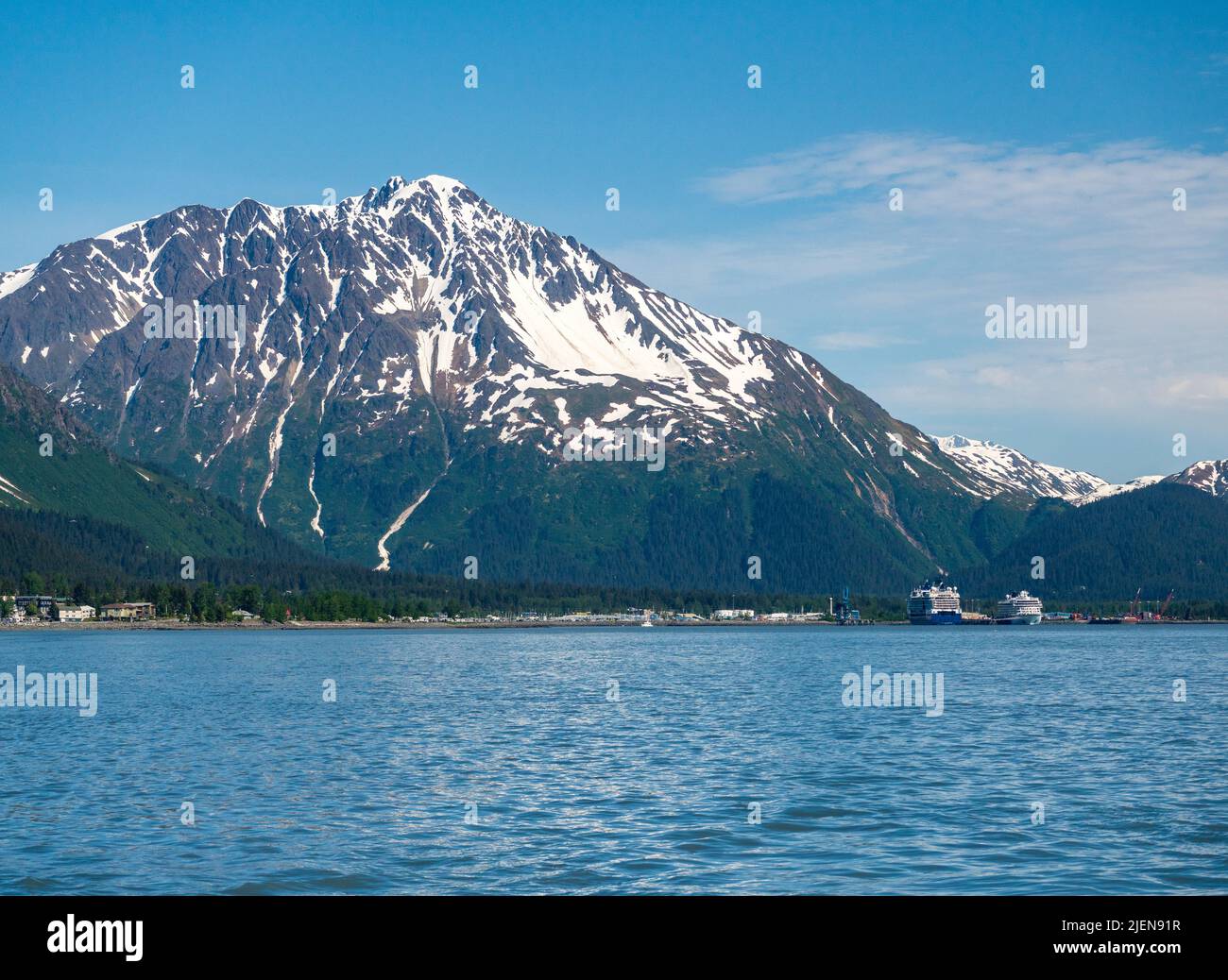 Snow covered peak of the mountain overlooking the port of Seward in ...