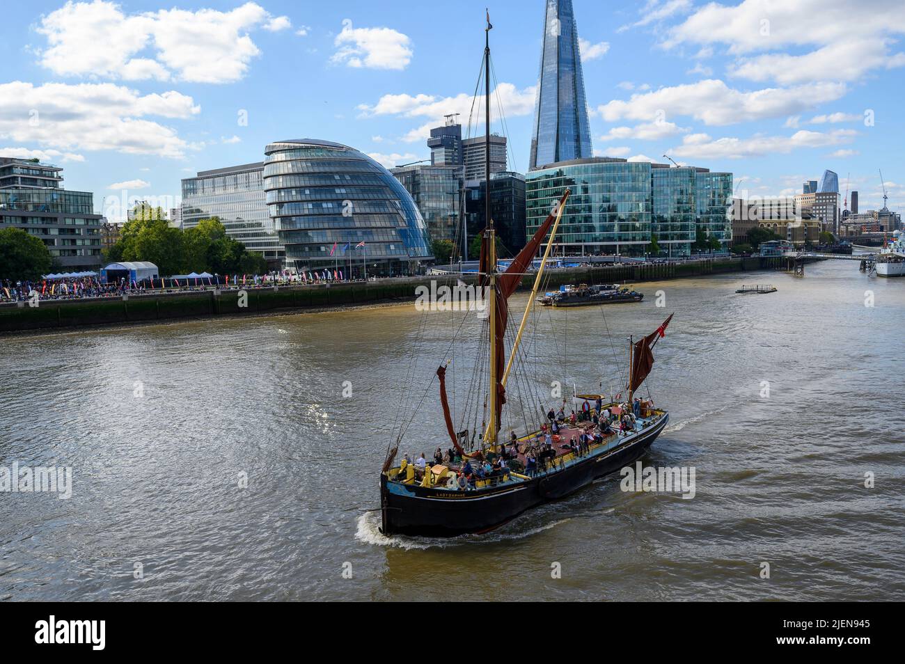 Old sailing barge sailing down the River Thames and under Tower Bridge ...