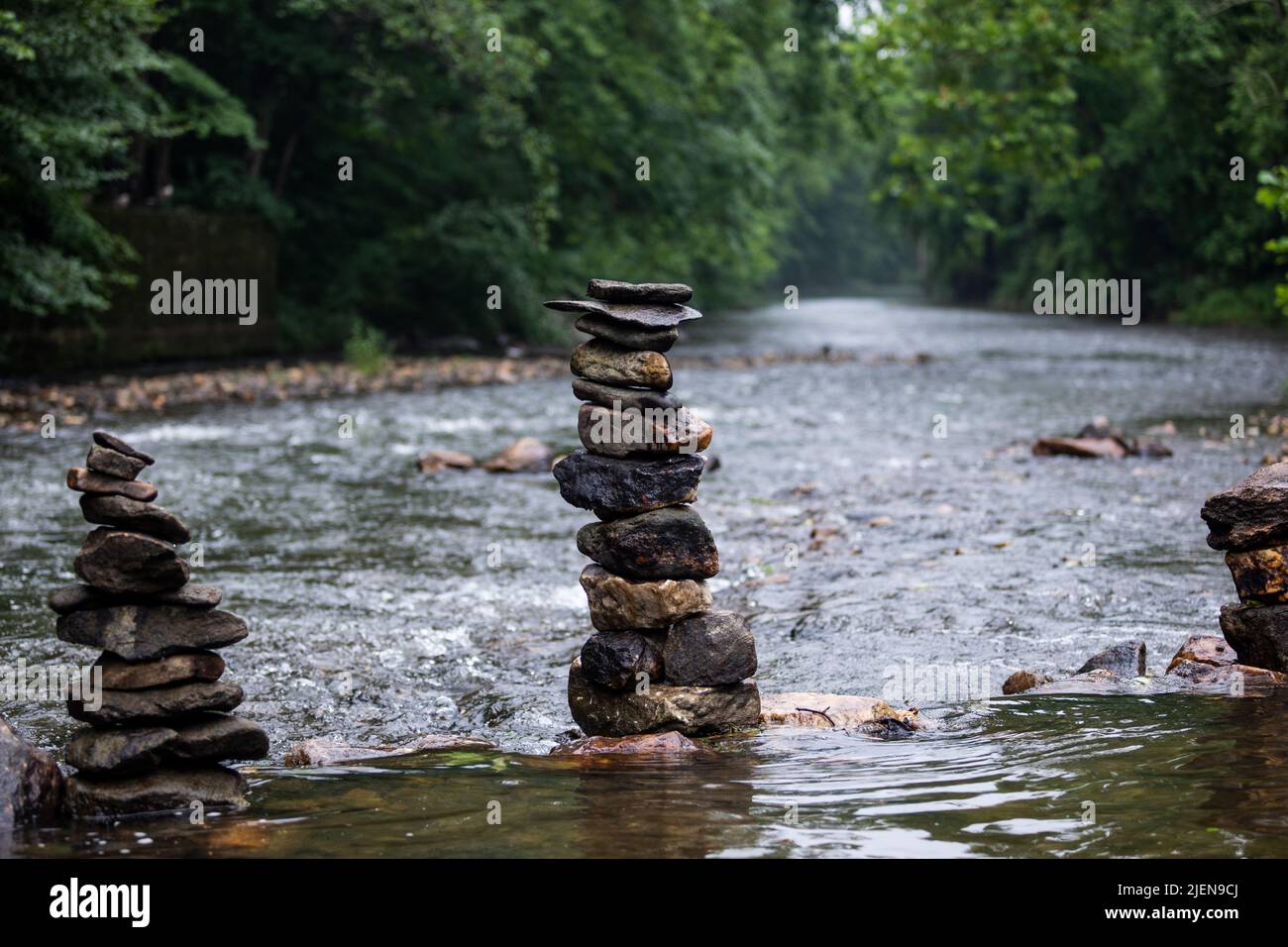 Stones Carefully Stacked on Gently Flowing River Stock Photo - Alamy