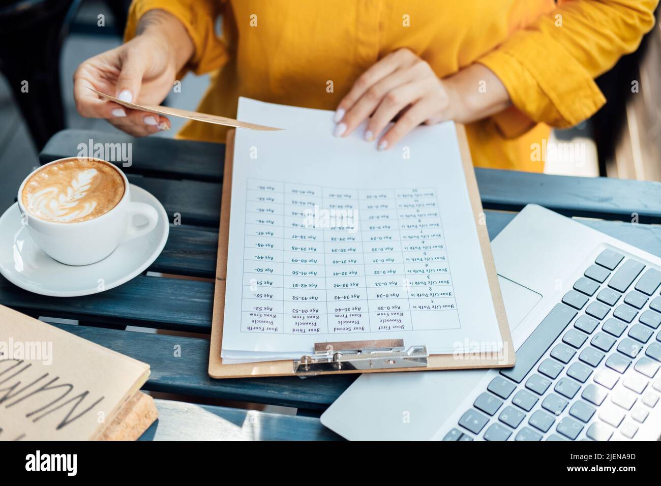 Female numerologist hand working with numerology tables with numbers ...