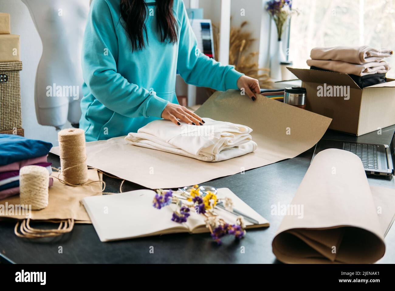 Small business owner woman packs the goods in eco packaging in office ...