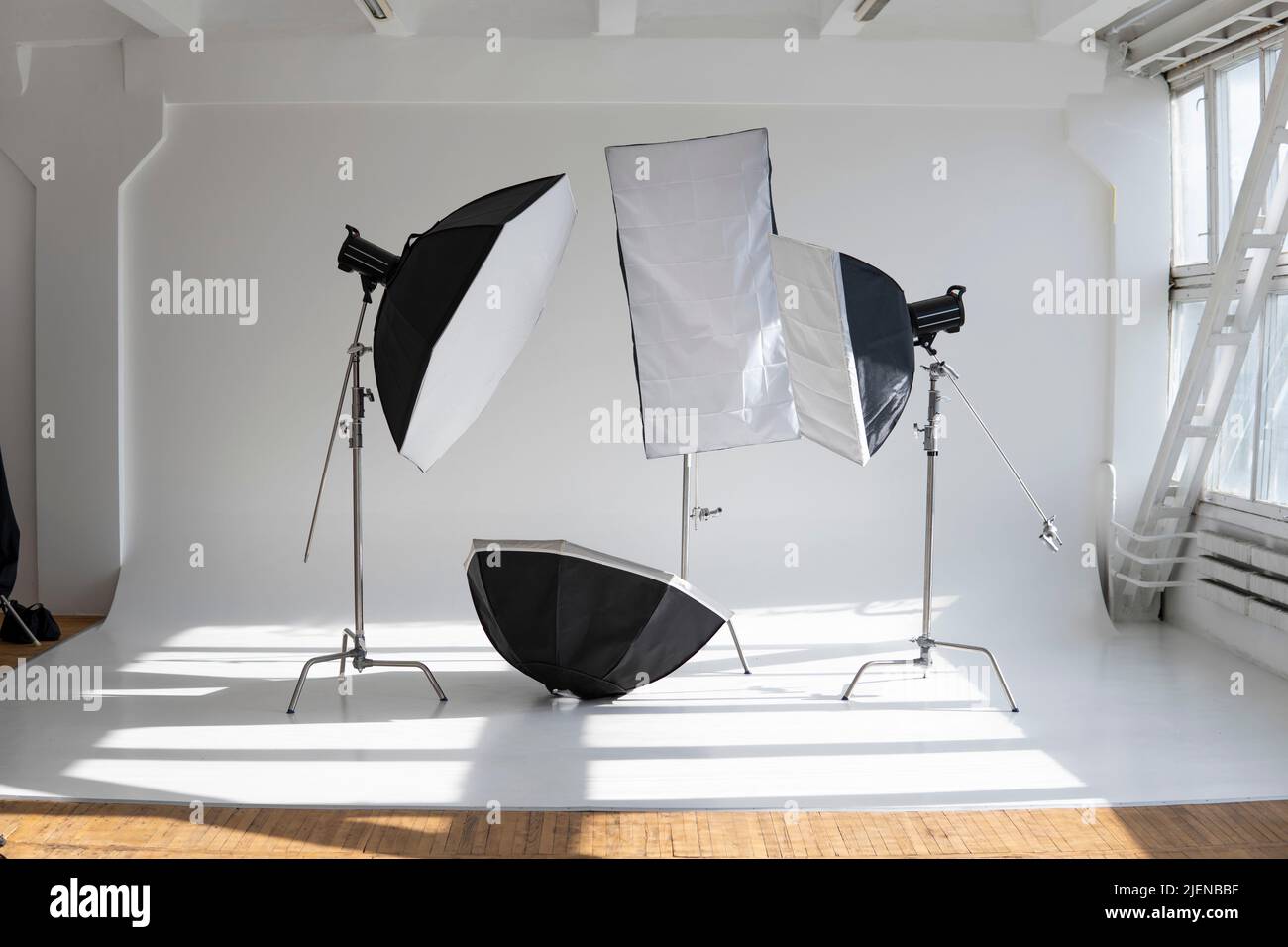 Professional lighting equipment, flashes, c-stands on a cyclorama in ...