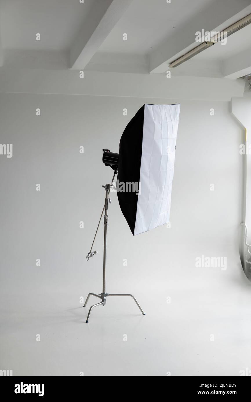 Professional photo flash light with a big softbox on a c-stand on a ...