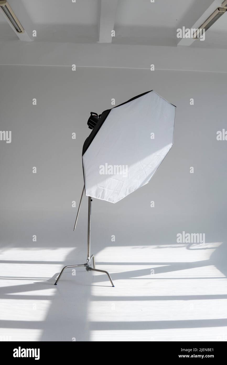 Professional photo flash light with a octbox on a c-stand on a ...