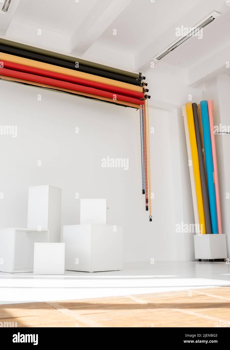 Sunny daylight photo studio interior with set rolls of color background ...
