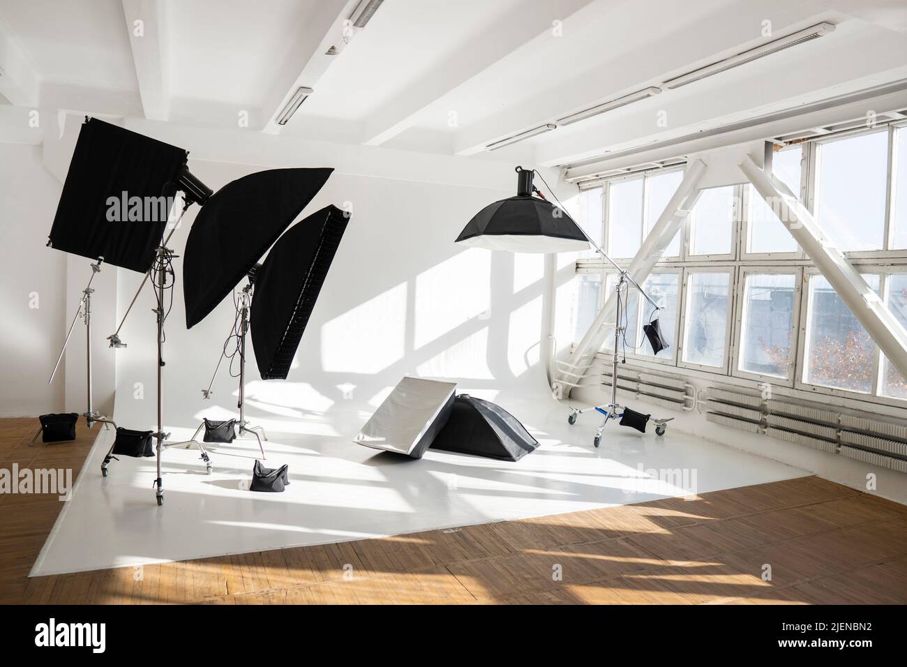 Professional lighting equipment, flashes, c-stands on a cyclorama in ...