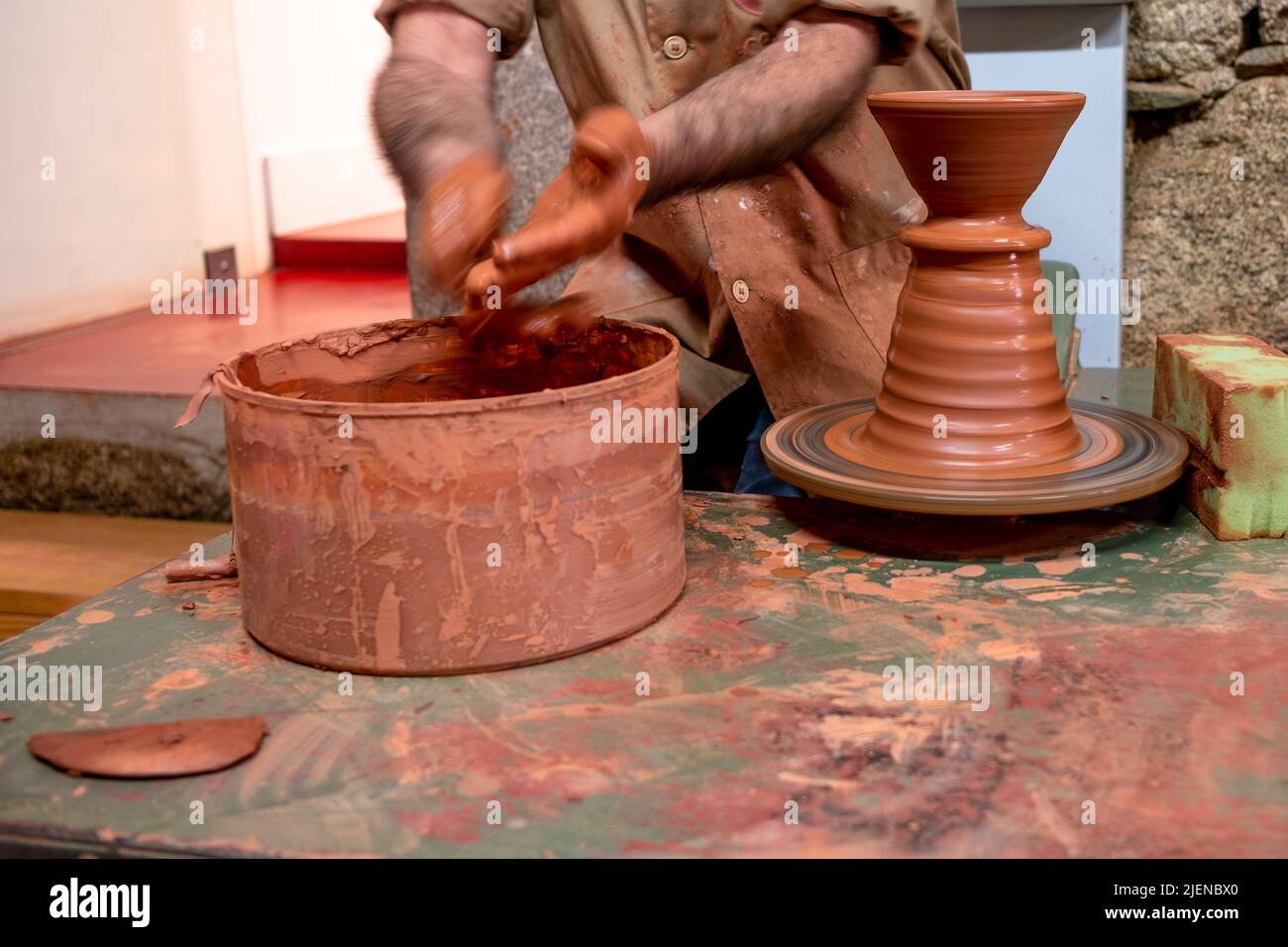 Craft hands making a clay pot. Men's hands. Potter at work. Creating ...