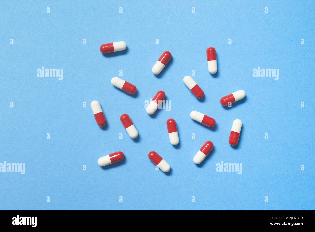 Pharmaceutical capsules over blue background Stock Photo - Alamy