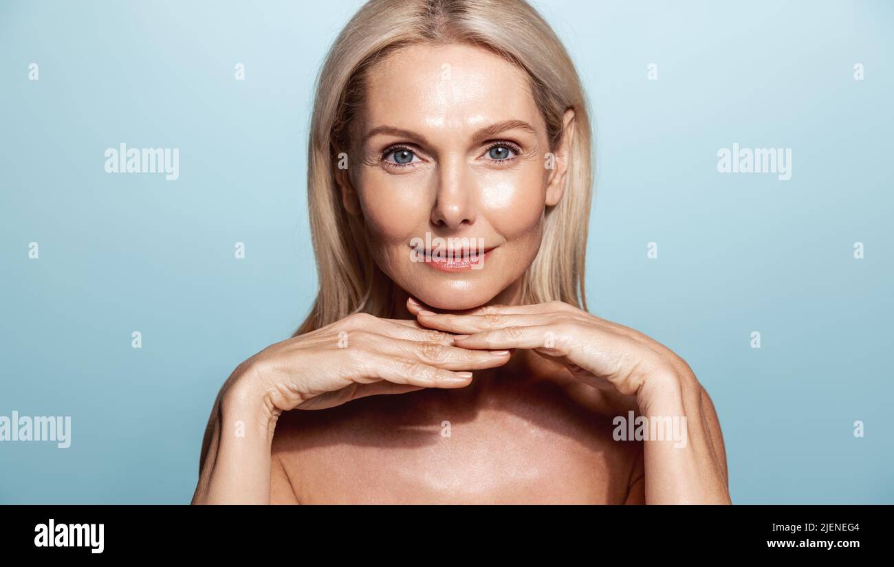 Beautiful middle aged woman with perfect face glow, using spa, anti ...
