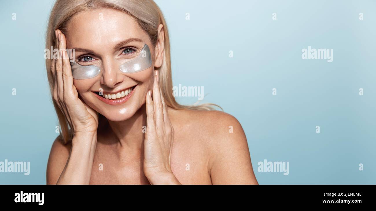 Skin care and spa. Beautiful middle aged woman with under eye patches ...