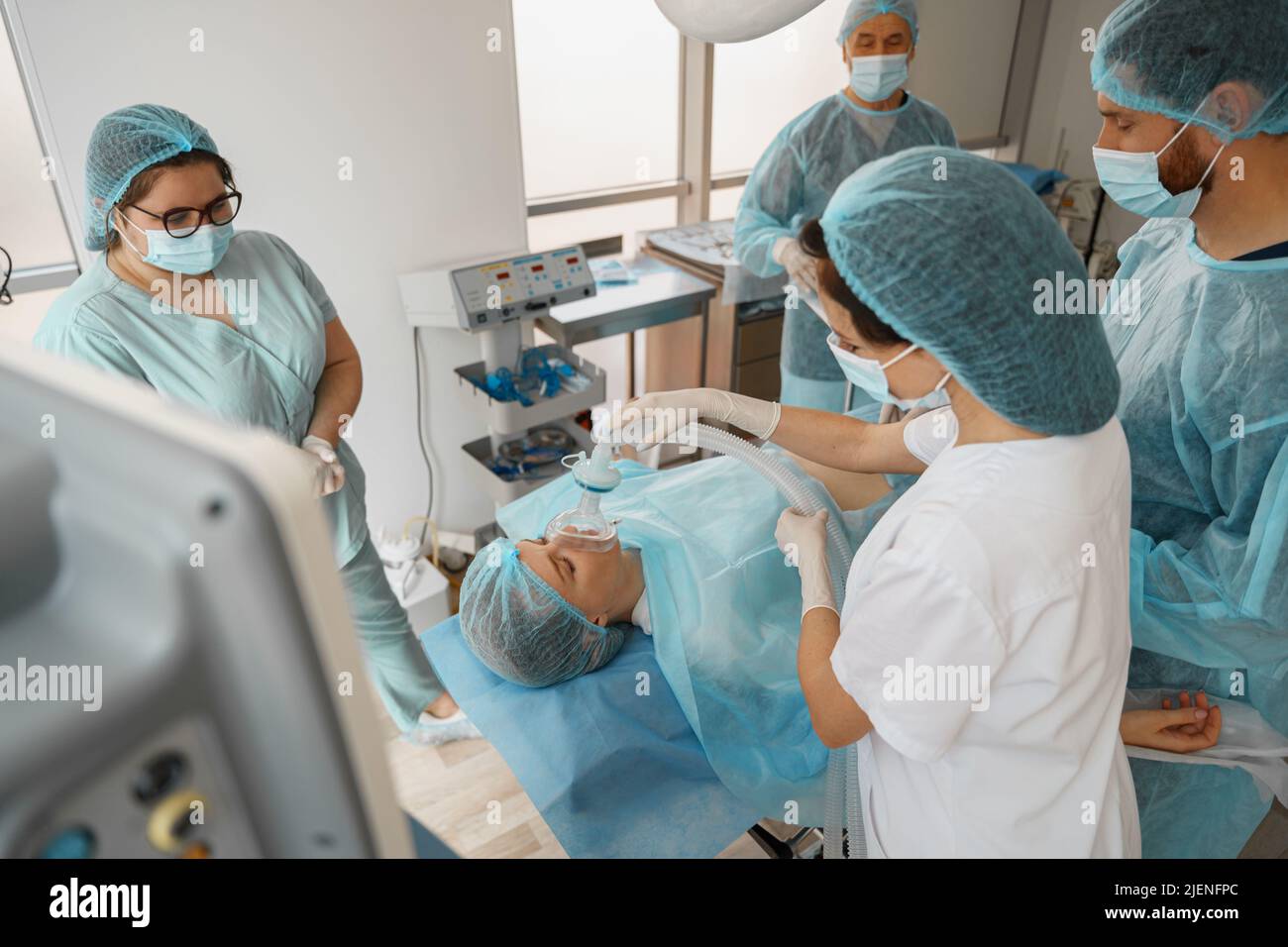 Well-trained anesthesiologist follows the patient during the surgery in ...