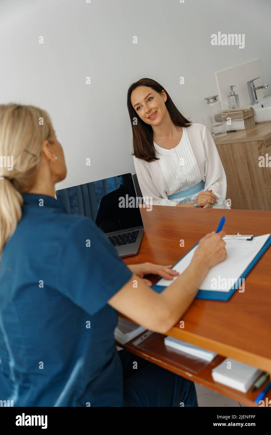 Doctor fills out the medical report form on medical care of patients ...