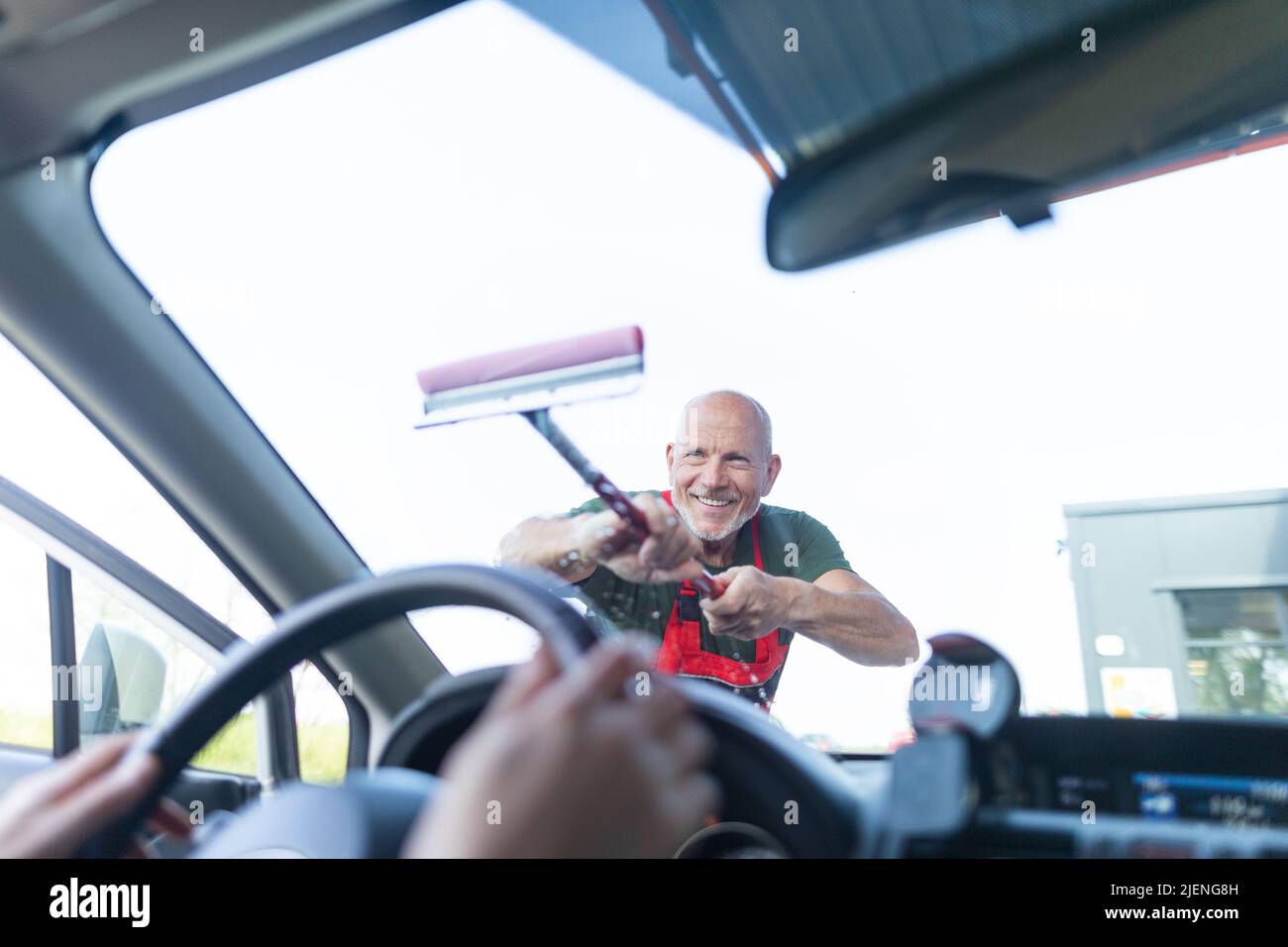Senior worker washing car window at gas station Stock Photo - Alamy