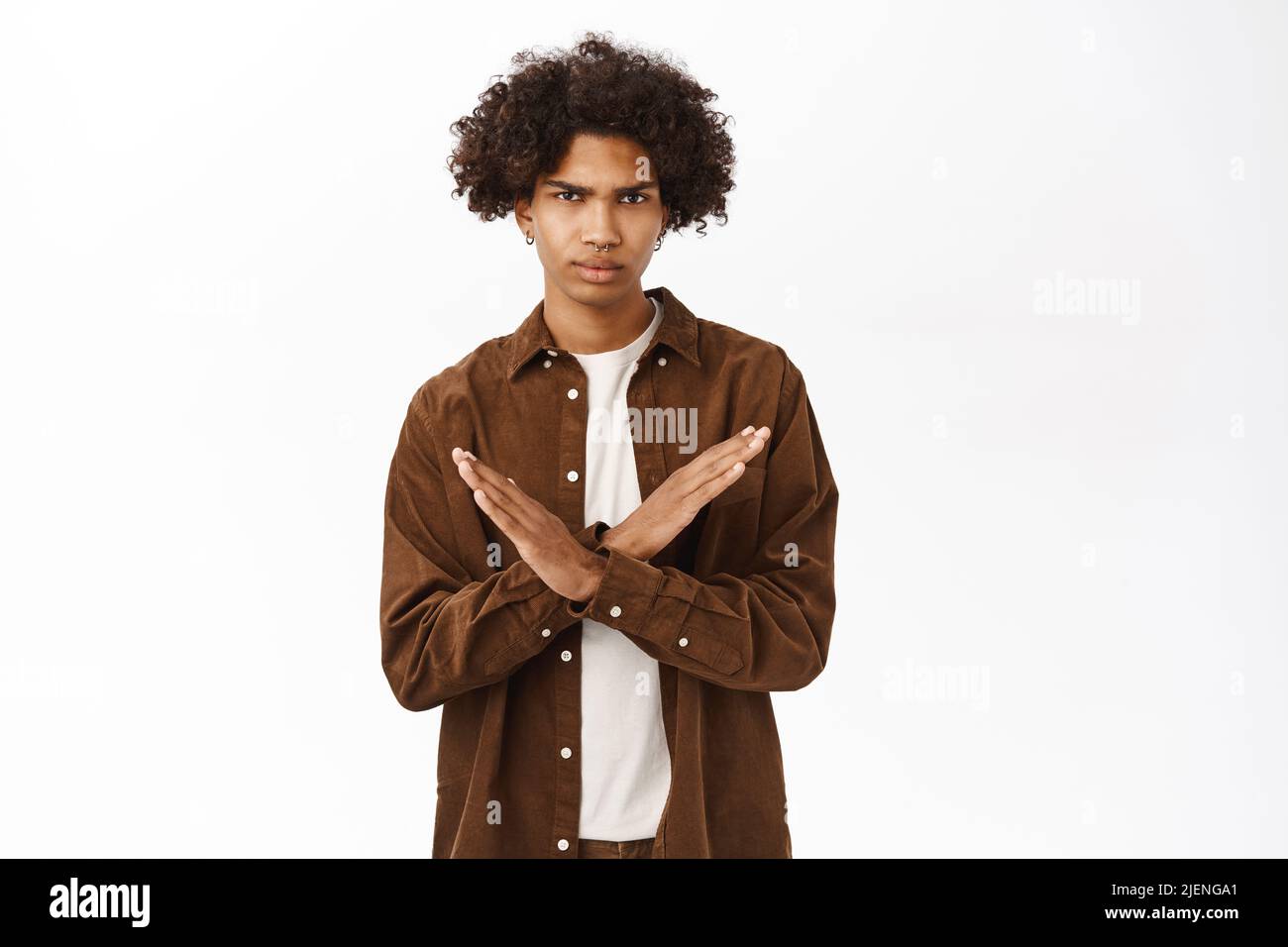 Dont like it. Upset young man shows stop, cross hands gesture ...
