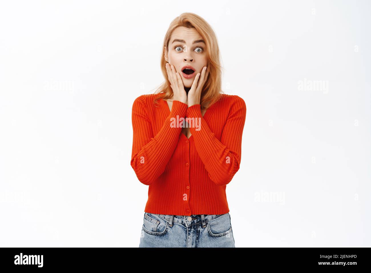 Shocked young woman looking amazed, drop jaw, staring with impressed ...