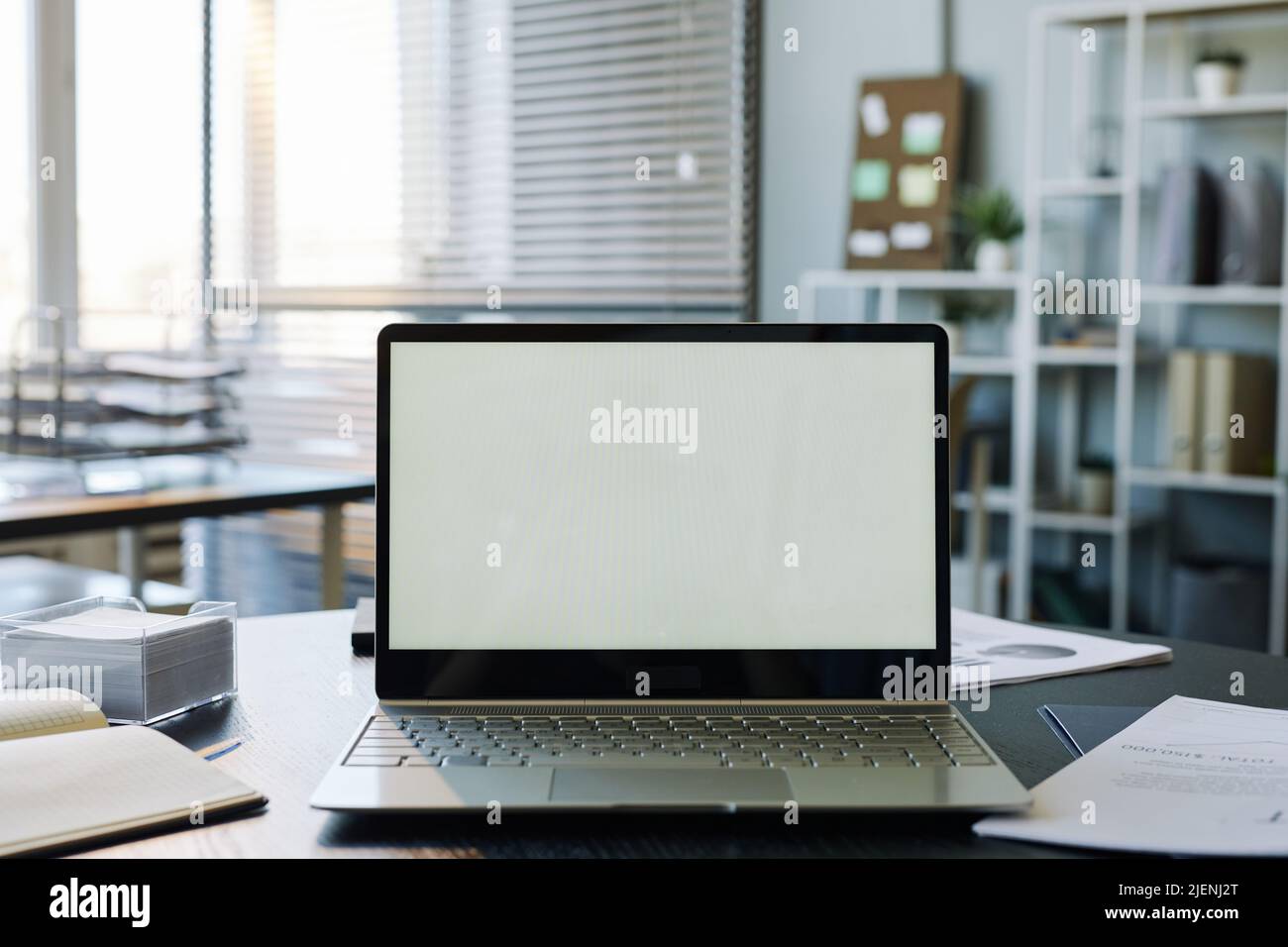 Background image of mock up computer with blank white screen in empty ...