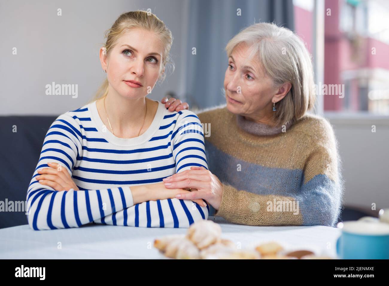 Elderly mother asks for forgiveness from her adult daughter after domestic quarrel Stock Photo ...