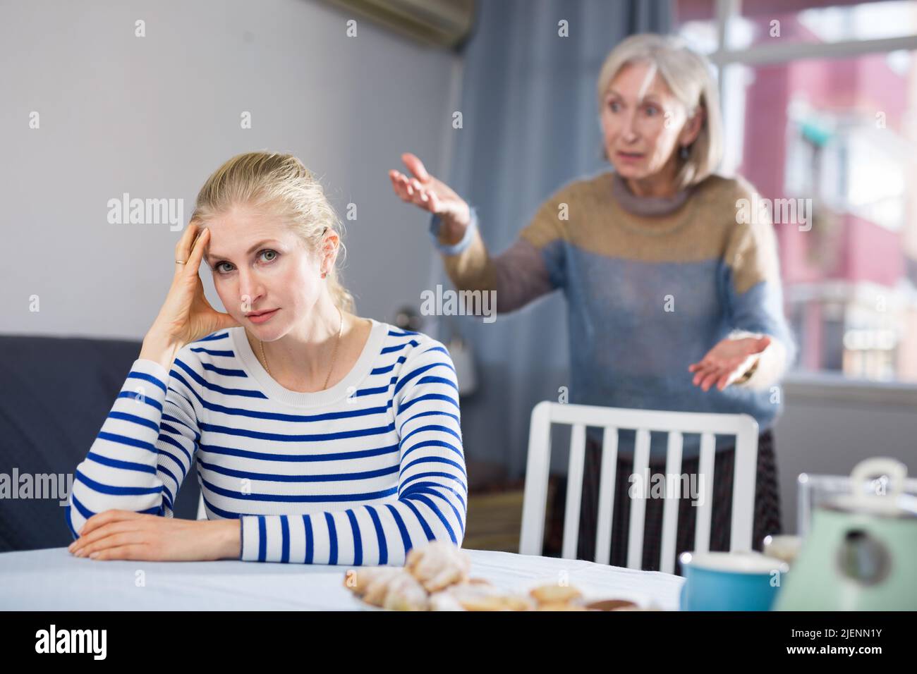 Elderly mother is aggressive against her adult daughter during quarrel ...